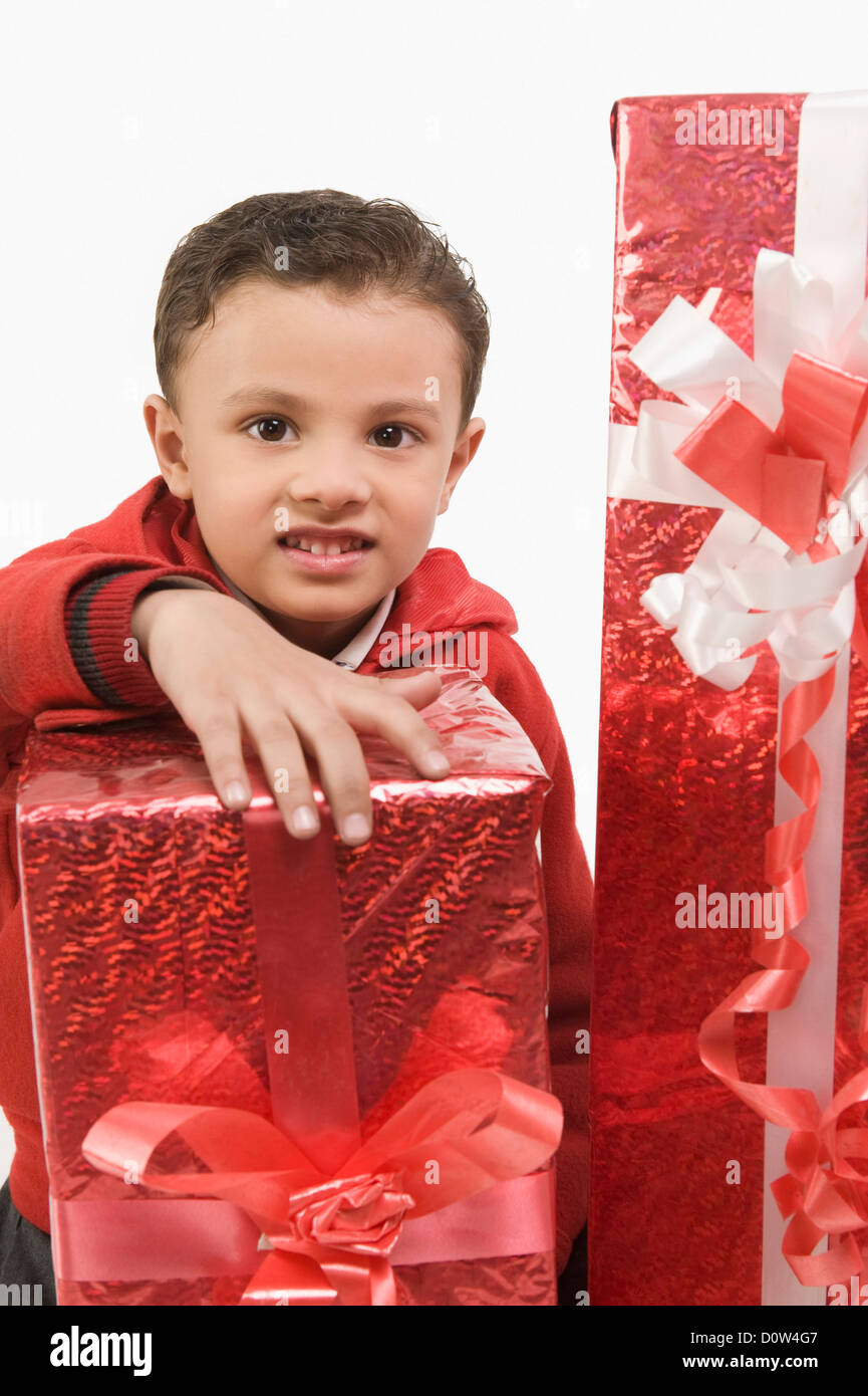 Boy holding a present and smiling Stock Photo - Alamy