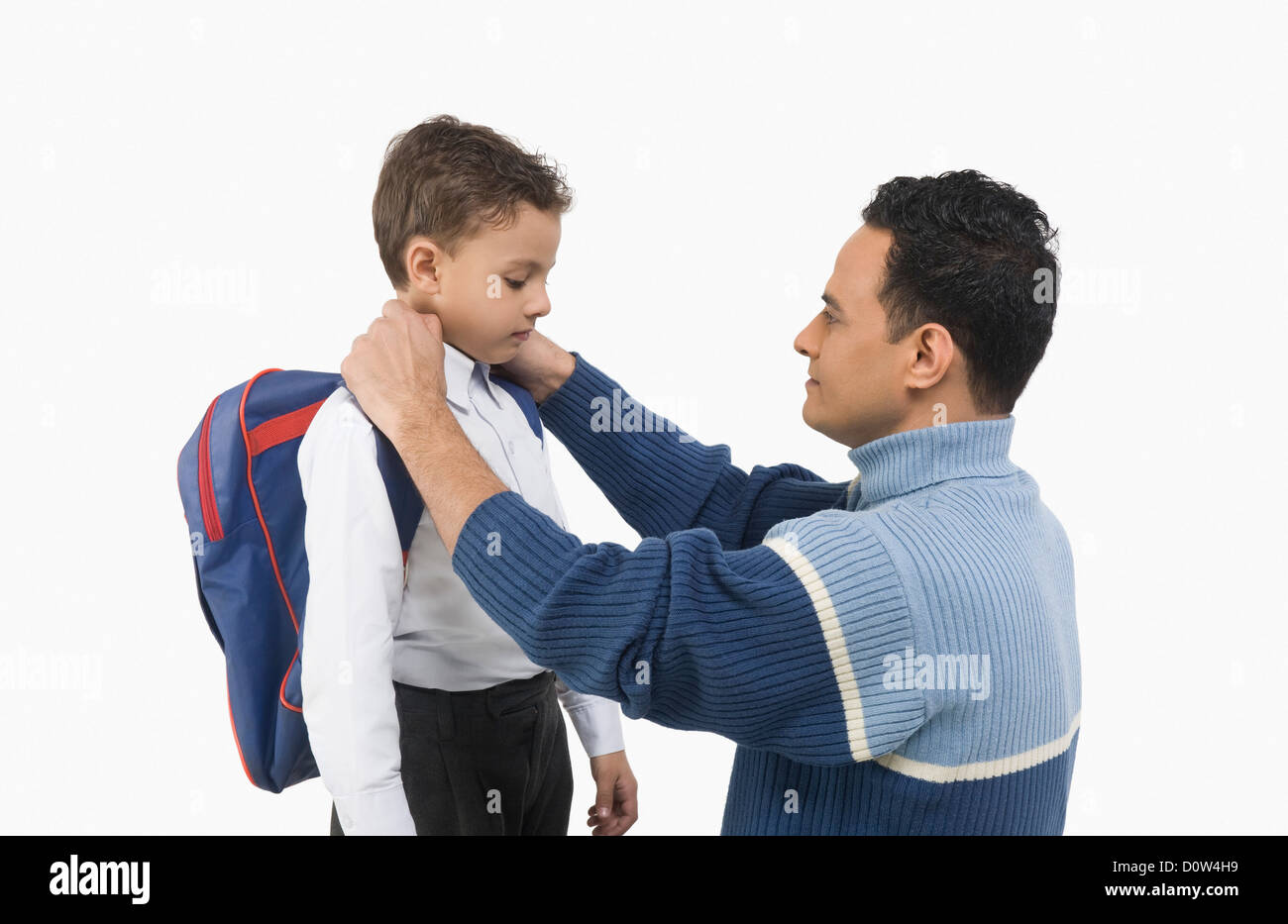 Man adjusting collar of his son Stock Photo - Alamy