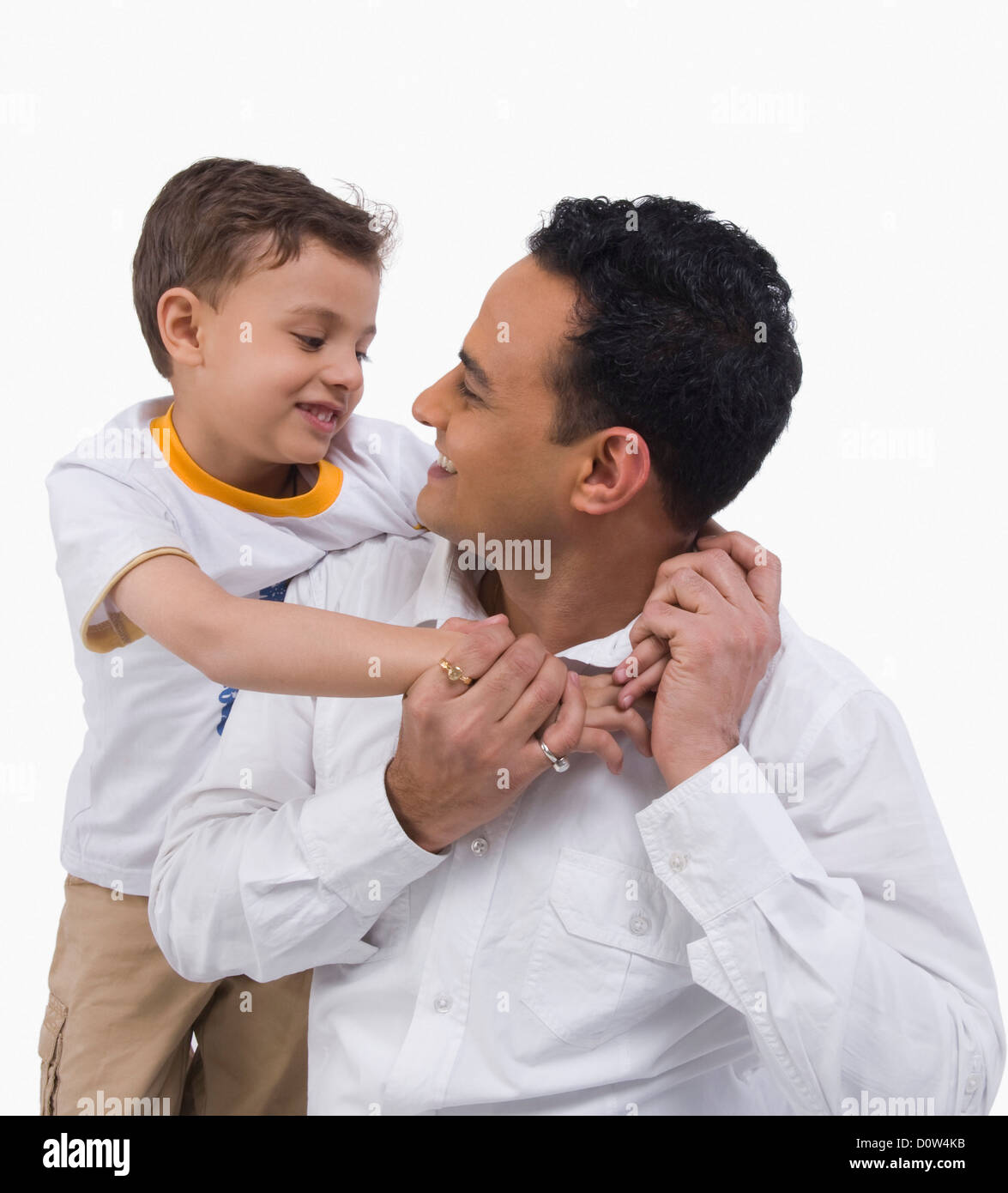 Boy hugging his father from behind Stock Photo - Alamy