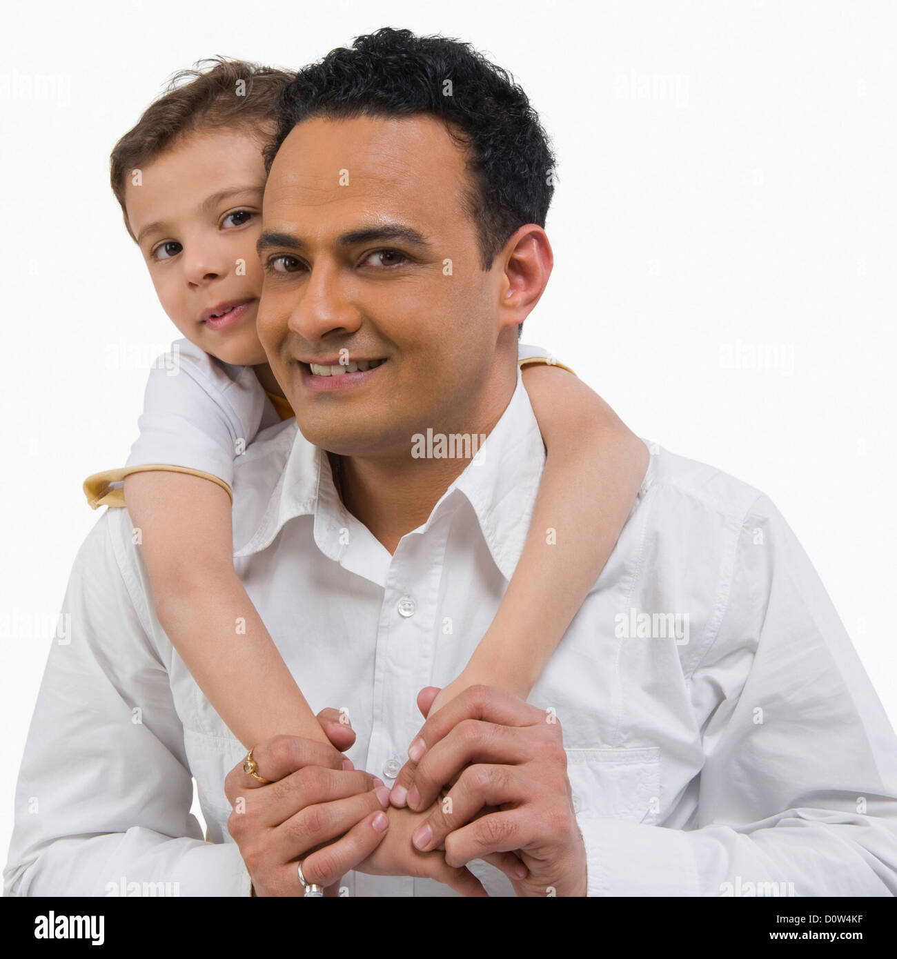 Boy hugging his father from behind Stock Photo - Alamy