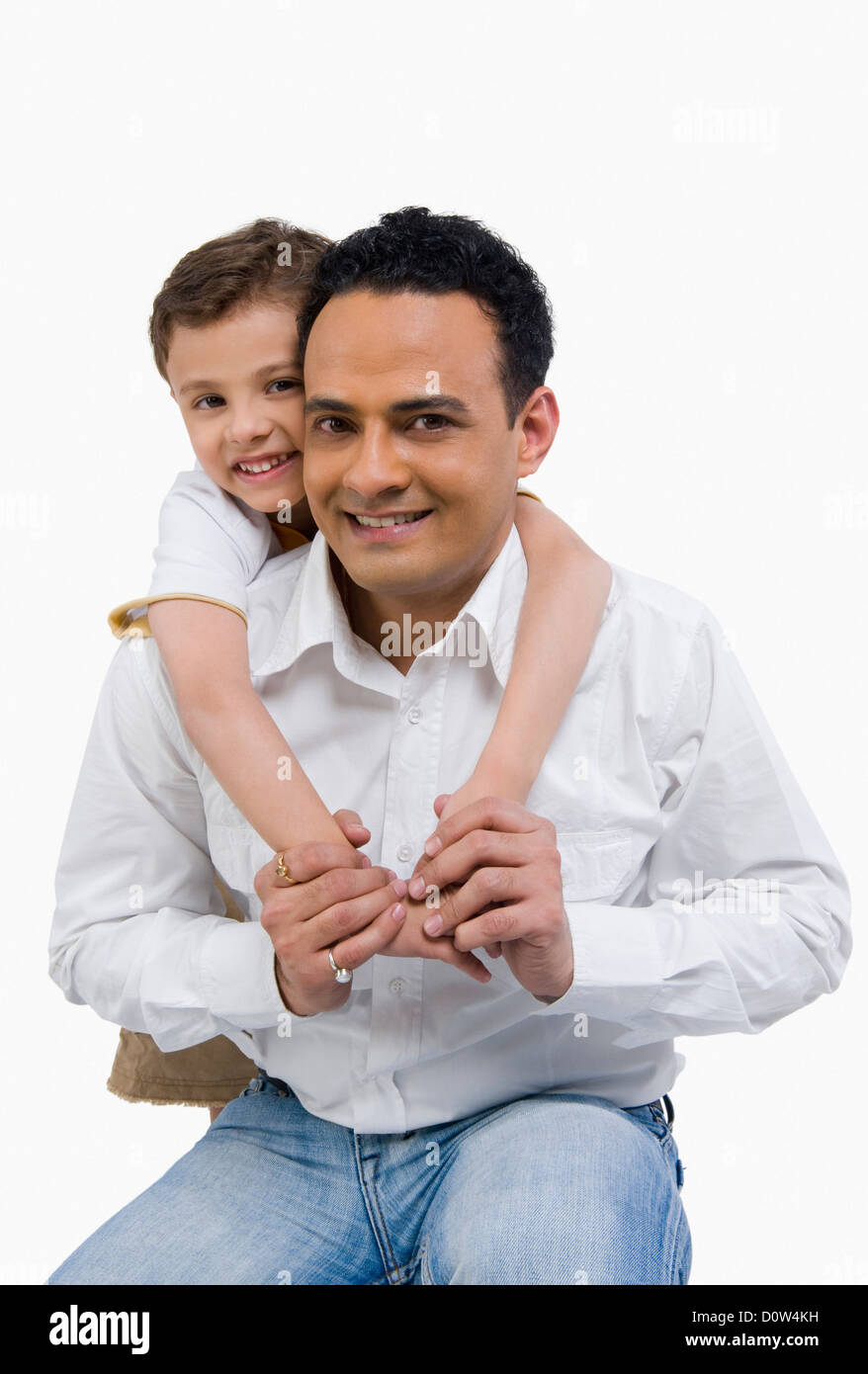 Boy hugging his father from behind Stock Photo - Alamy