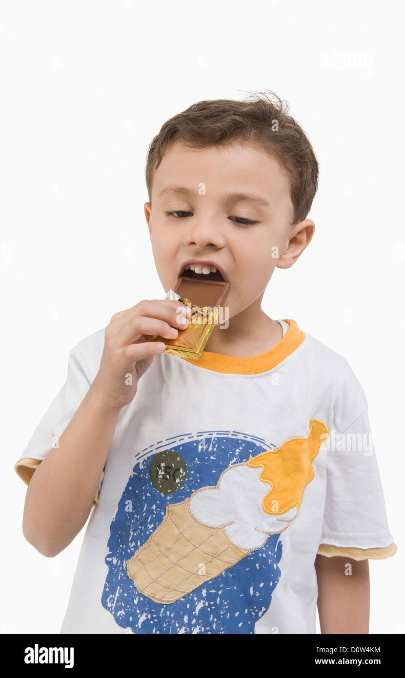 Boy eating a chocolate Stock Photo - Alamy
