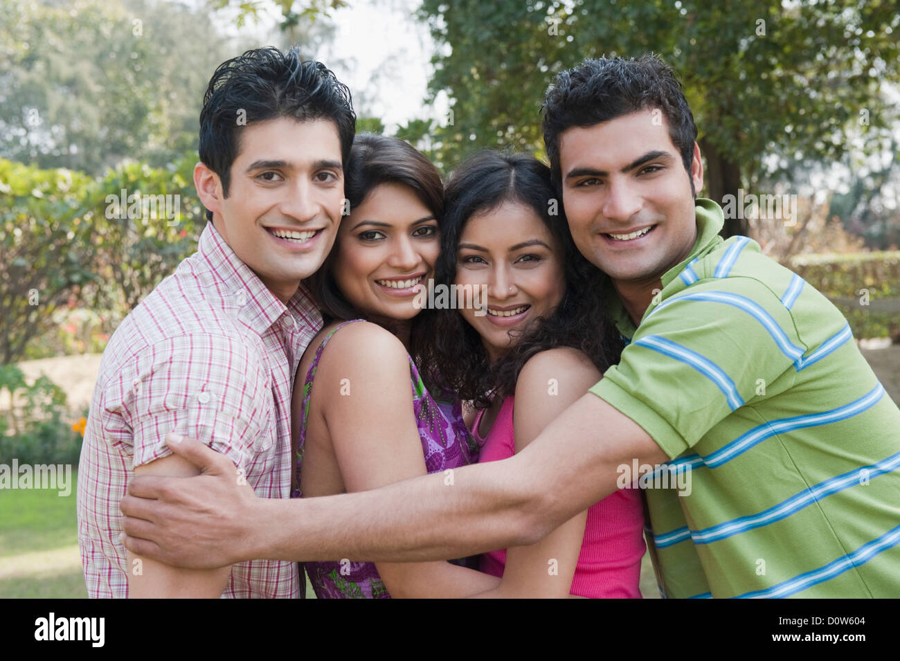 Portrait of four friends hugging each other Stock Photo - Alamy