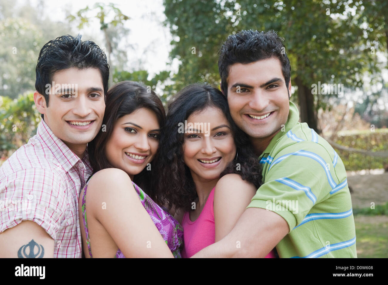 Portrait of four friends hugging each other Stock Photo - Alamy