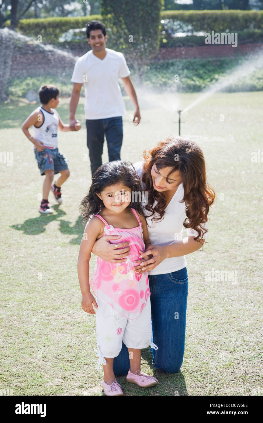 Family enjoying near a sprinkler, Gurgaon, Haryana, India Stock Photo ...