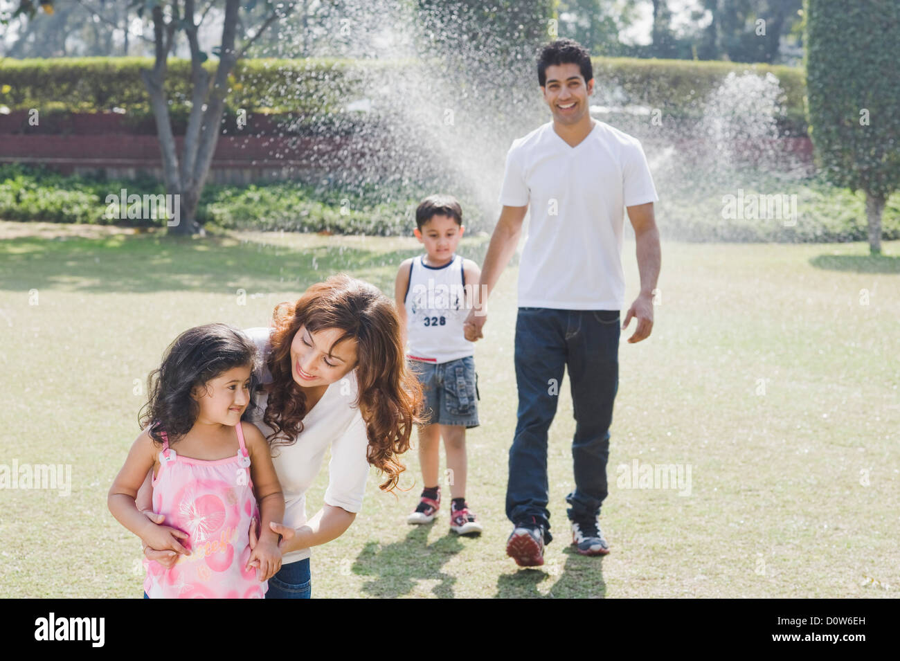 Child playing garden sprinkler preschooler hi-res stock photography and ...