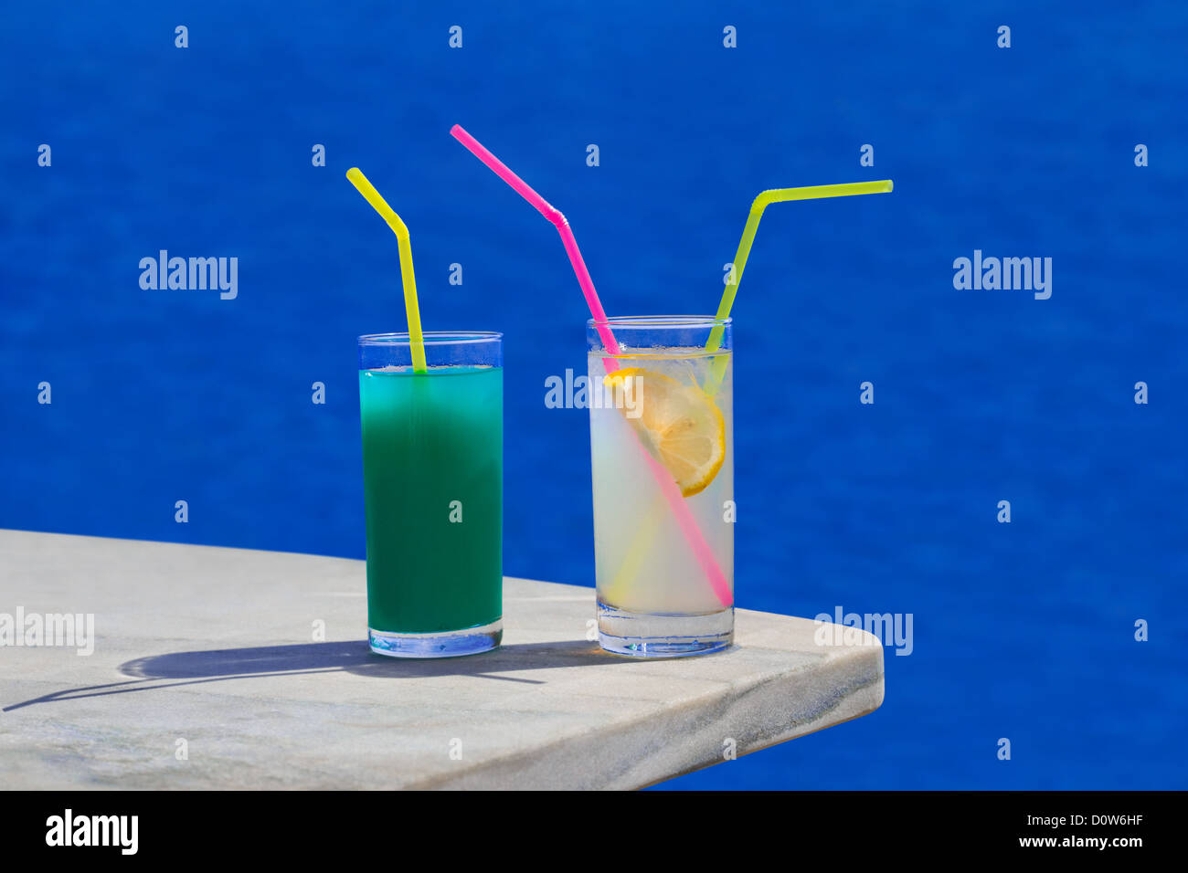 Two cocktails on table at beach Stock Photo - Alamy