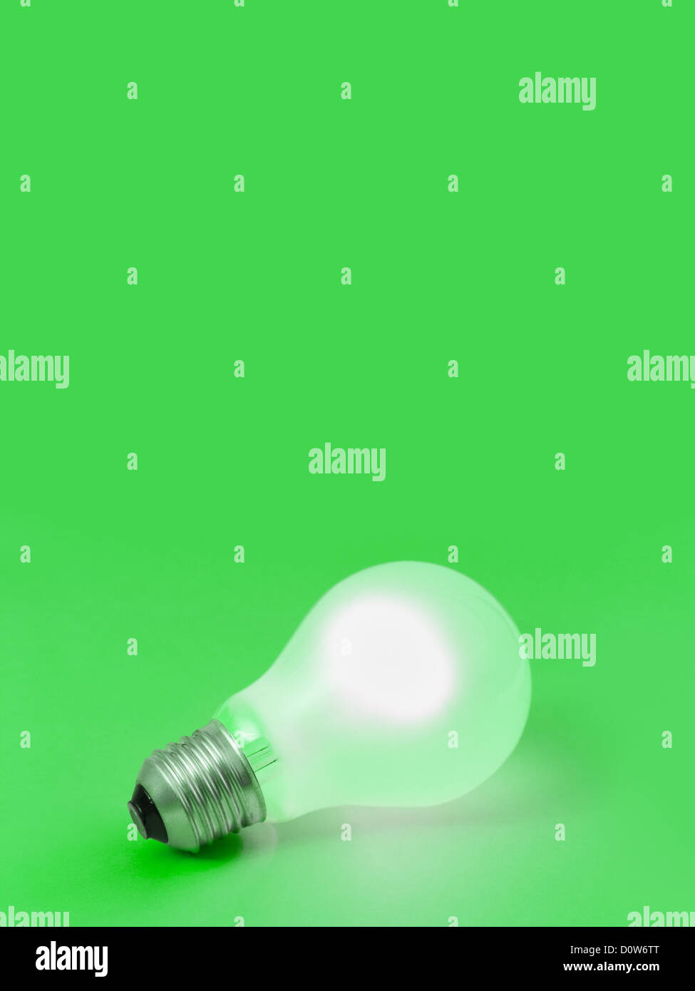 Lighting lamp on green background Stock Photo - Alamy