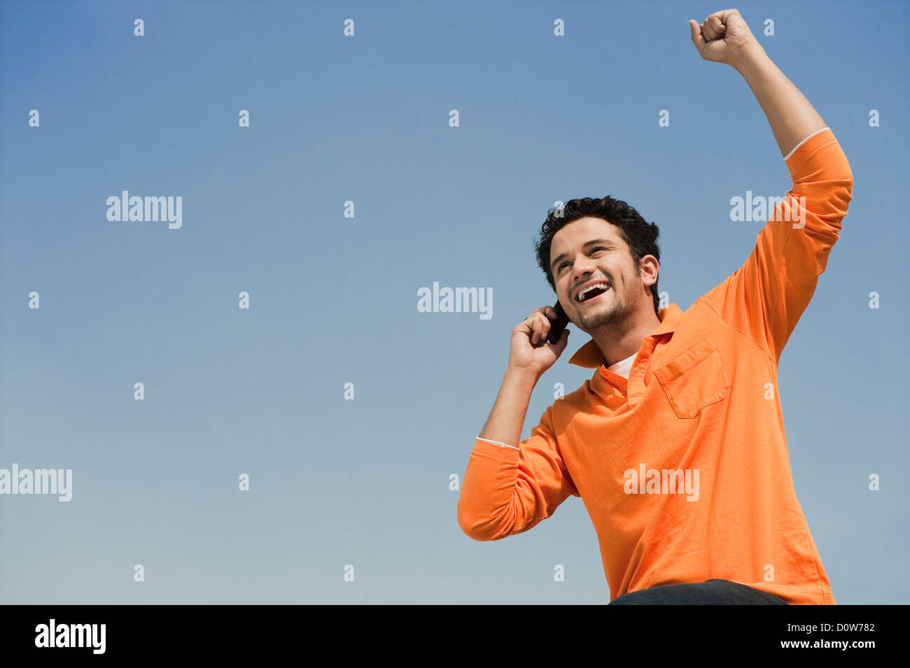 Man talking on a mobile phone and looking excited Stock Photo - Alamy