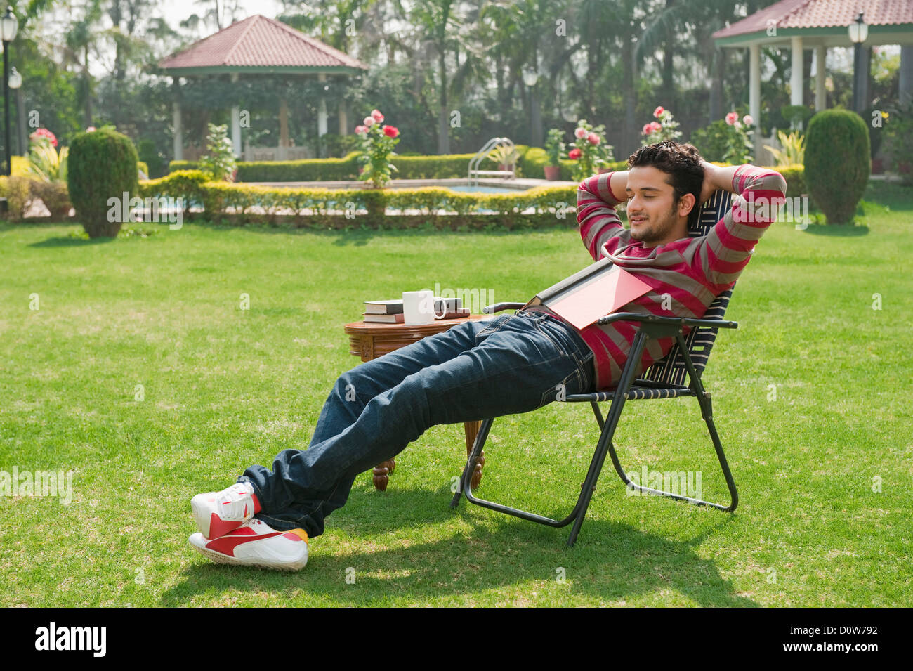 Man napping in a garden Stock Photo - Alamy