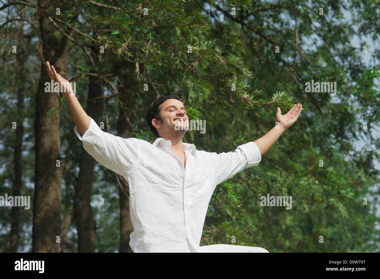 Man smiling with his arm outstretched Stock Photo - Alamy