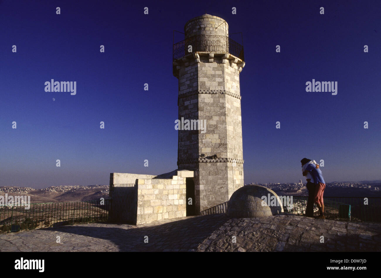 A young couple hug over the dome of Nabi Samwil mosque built over the ...