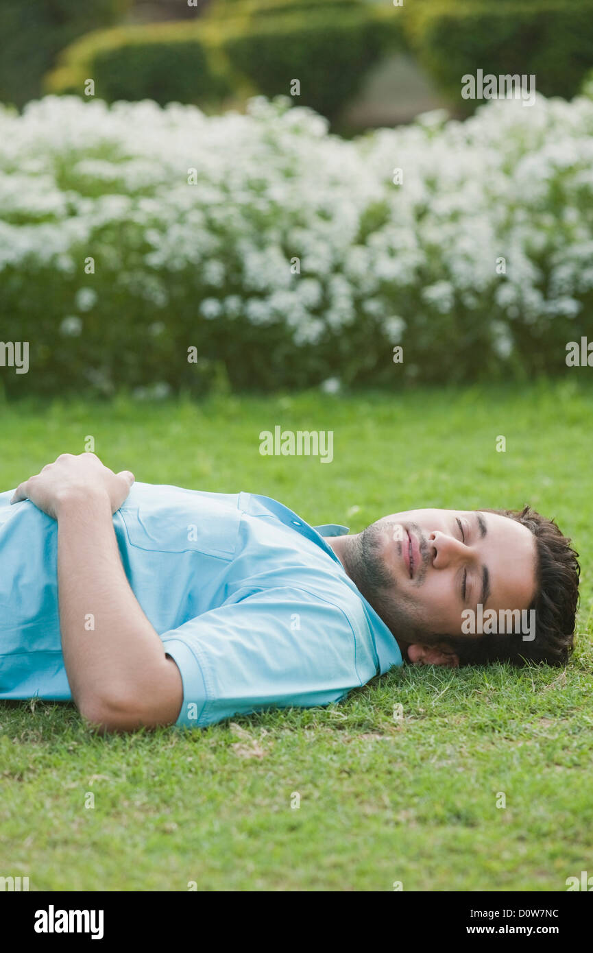 Man napping in a garden Stock Photo - Alamy