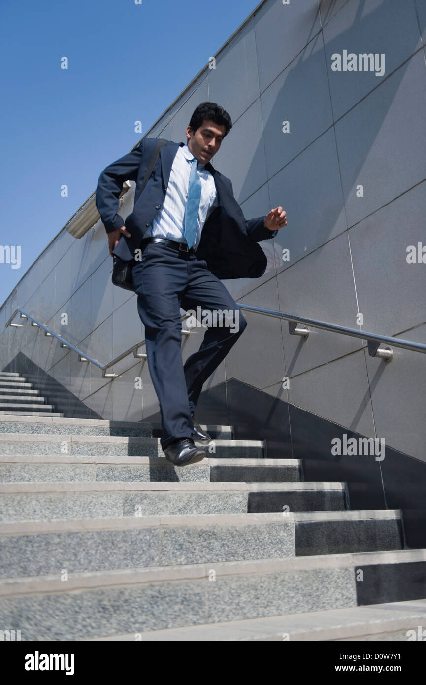 Businessman rushing down stairs of a subway, Gurgaon, Haryana, India ...