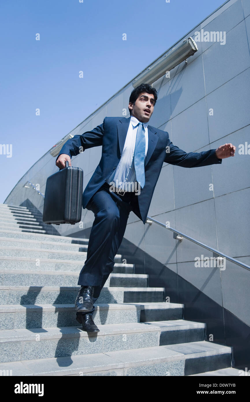 Businessman rushing down stairs of a subway, Gurgaon, Haryana, India ...