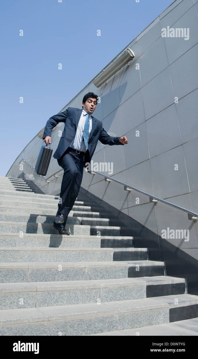 Businessman rushing down stairs of a subway, Gurgaon, Haryana, India ...