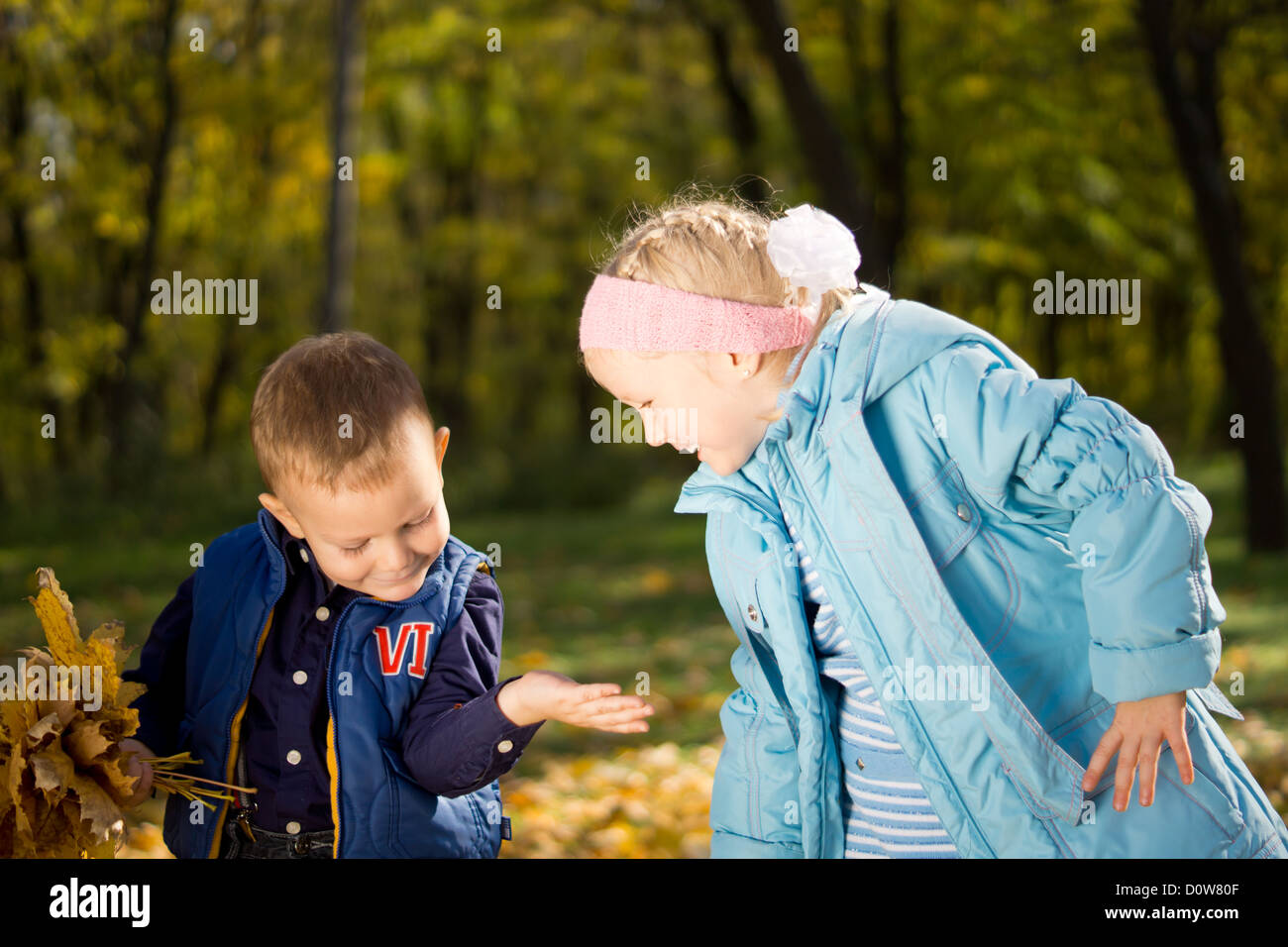 Excited small children watching a bug crawling over the little boy's ...