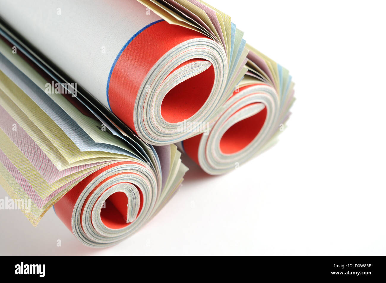 Rolled magazines on white background Stock Photo - Alamy