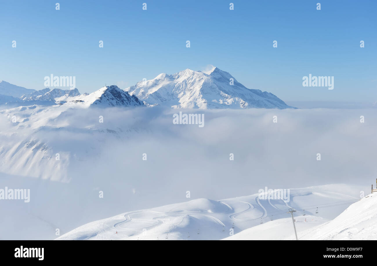 Mountains in clouds with snow in winter Stock Photo - Alamy