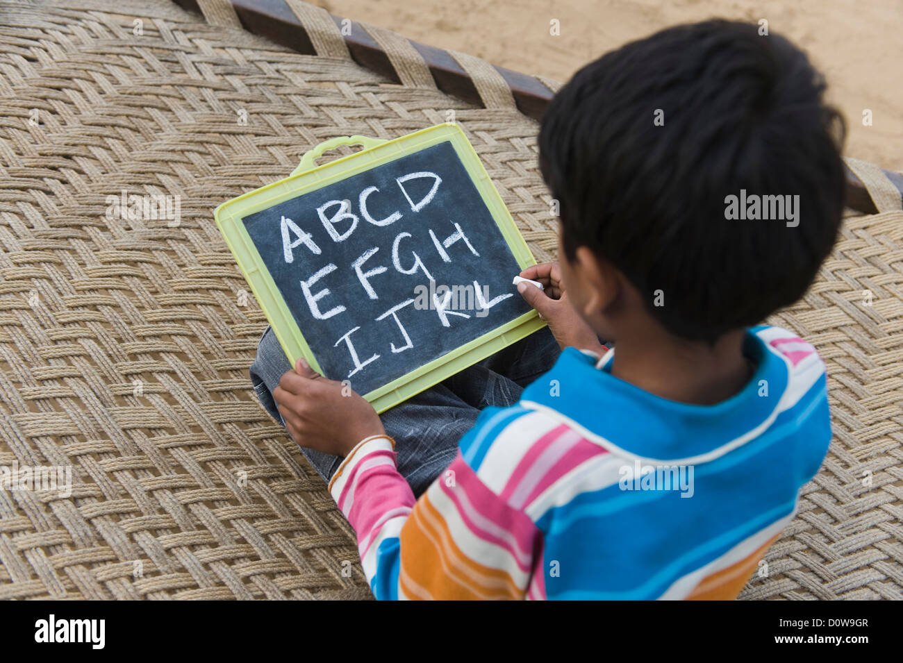 Boy writing on a slate, Hasanpur, Haryana, India Stock Photo - Alamy