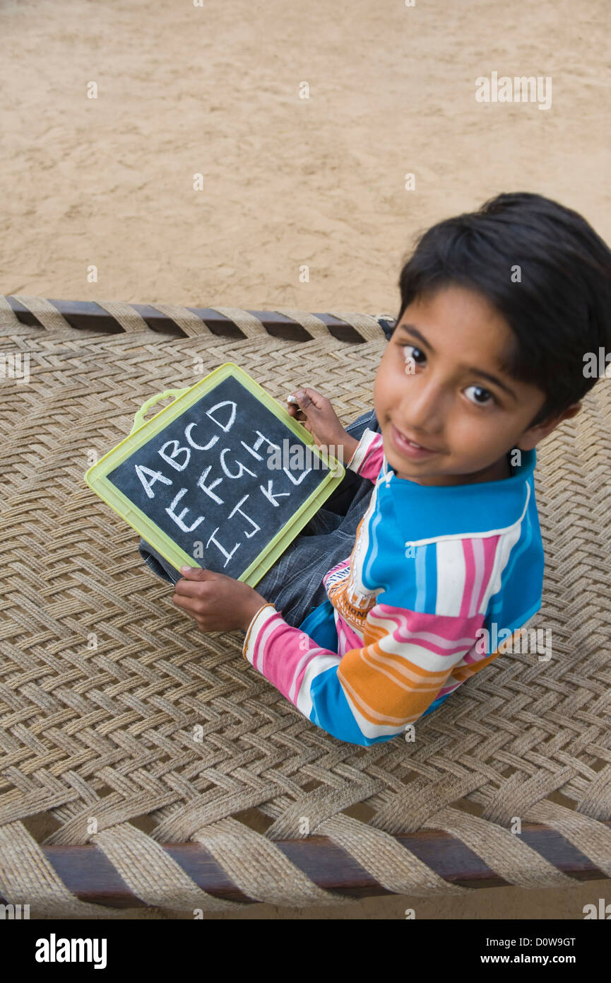 Asian boy writing on blackboard hi-res stock photography and images - Alamy