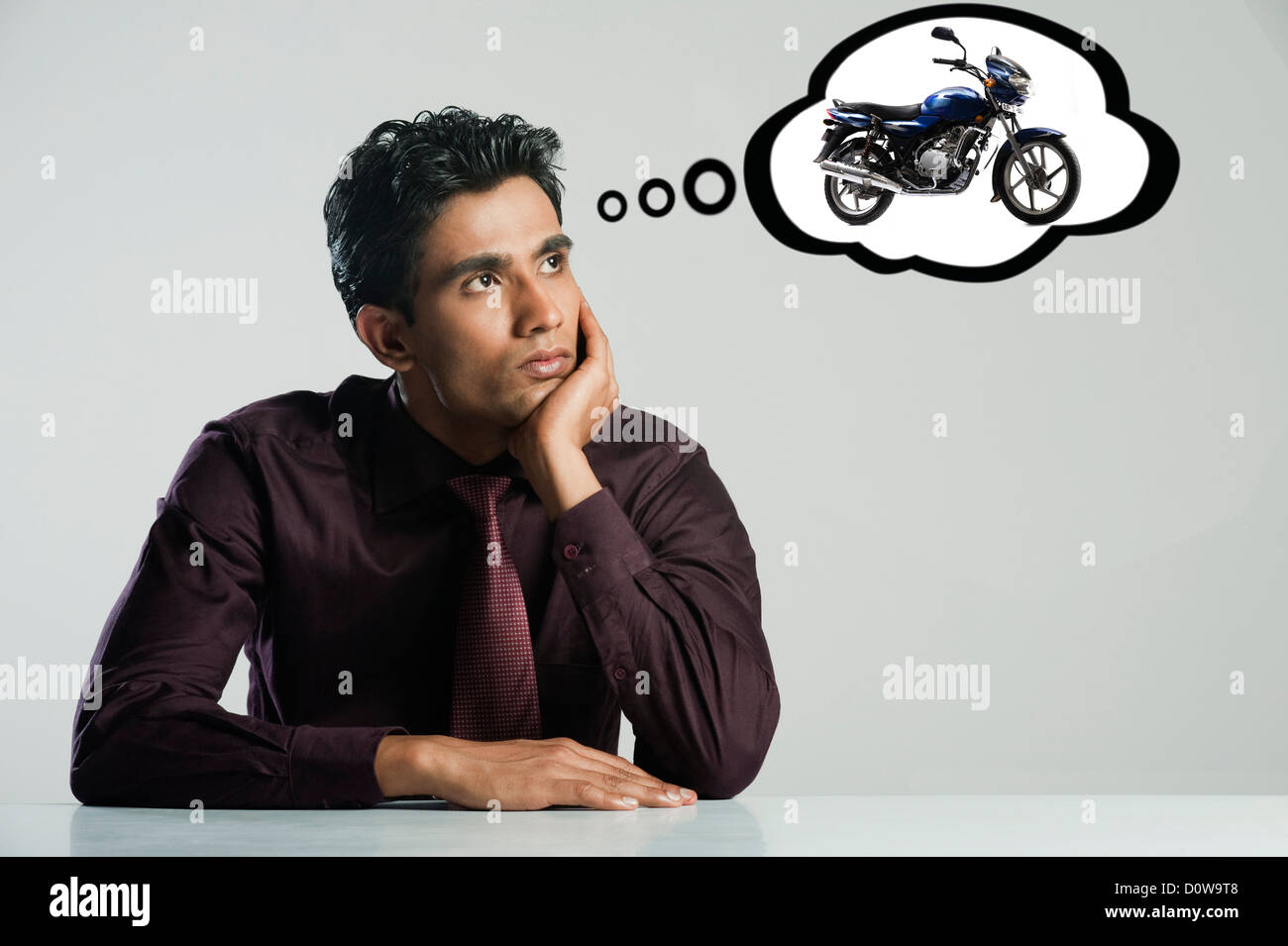 Businessman thinking about a motorcycle Stock Photo - Alamy