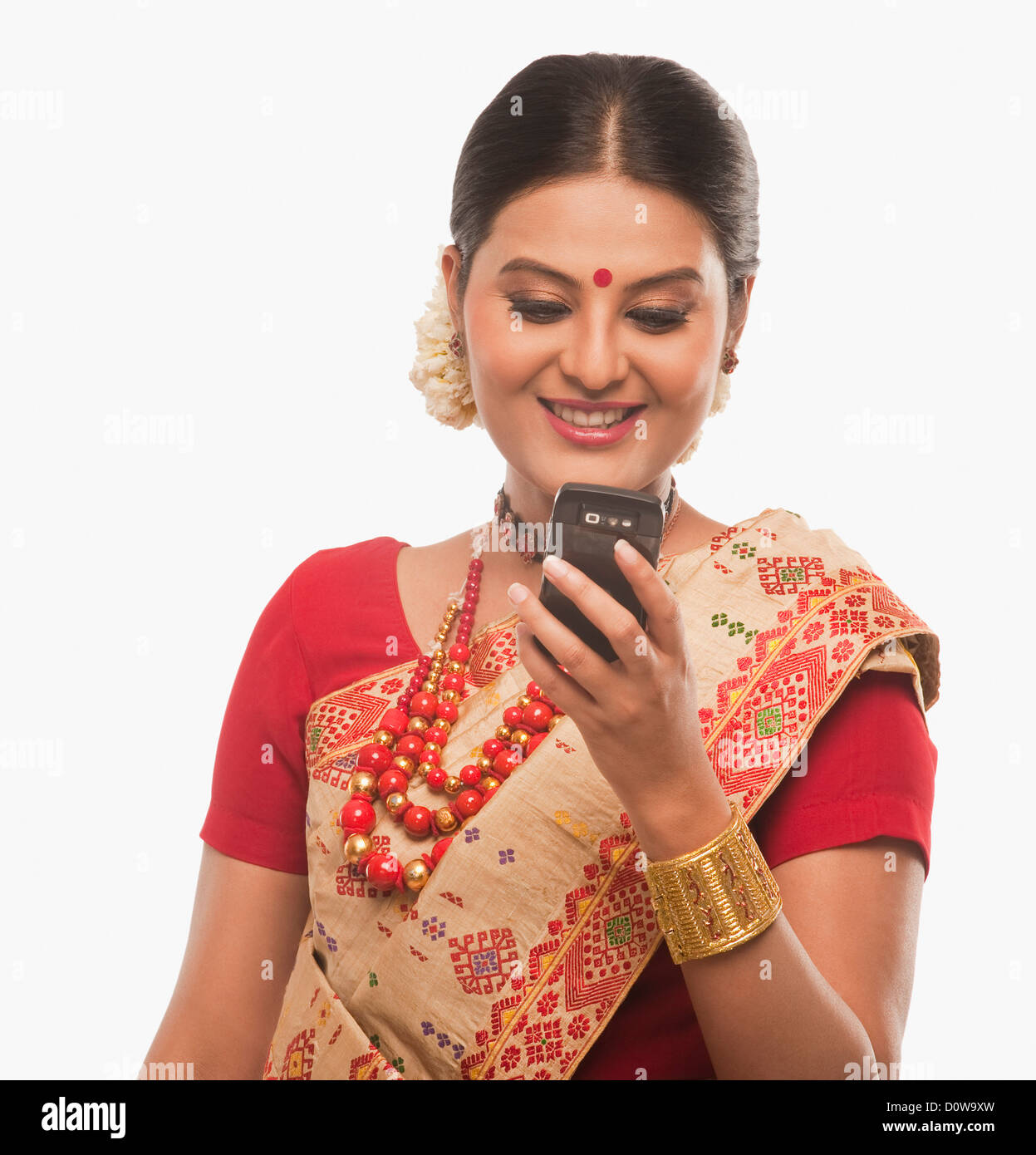Woman operating a mobile phone in traditional clothing Stock Photo - Alamy