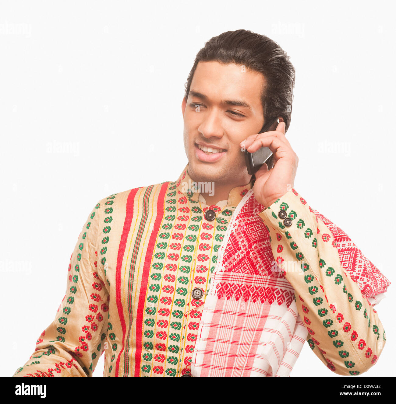 Man talking on a mobile phone in traditional clothing Stock Photo - Alamy