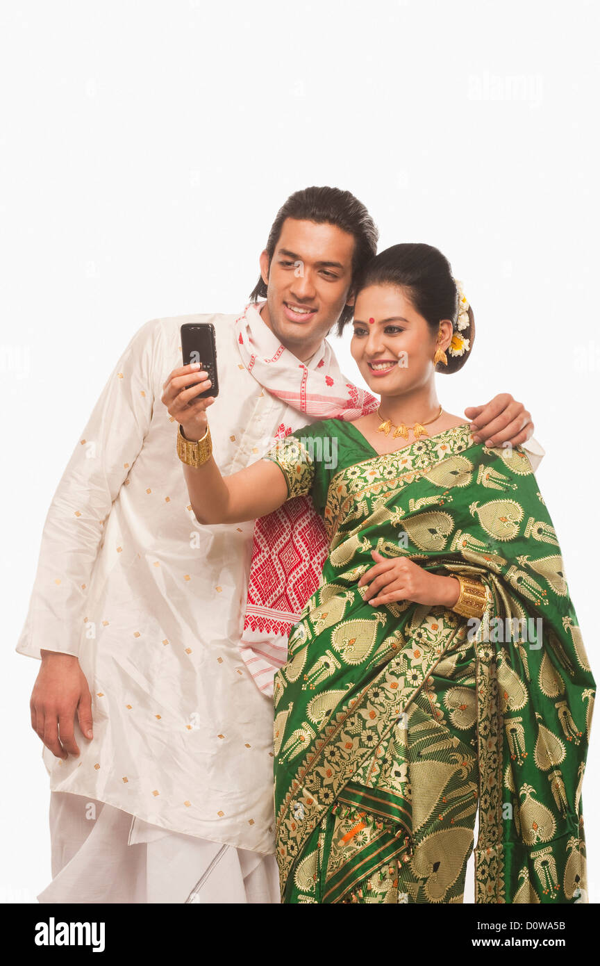 Couple in traditional clothing taking a picture of themselves Stock ...