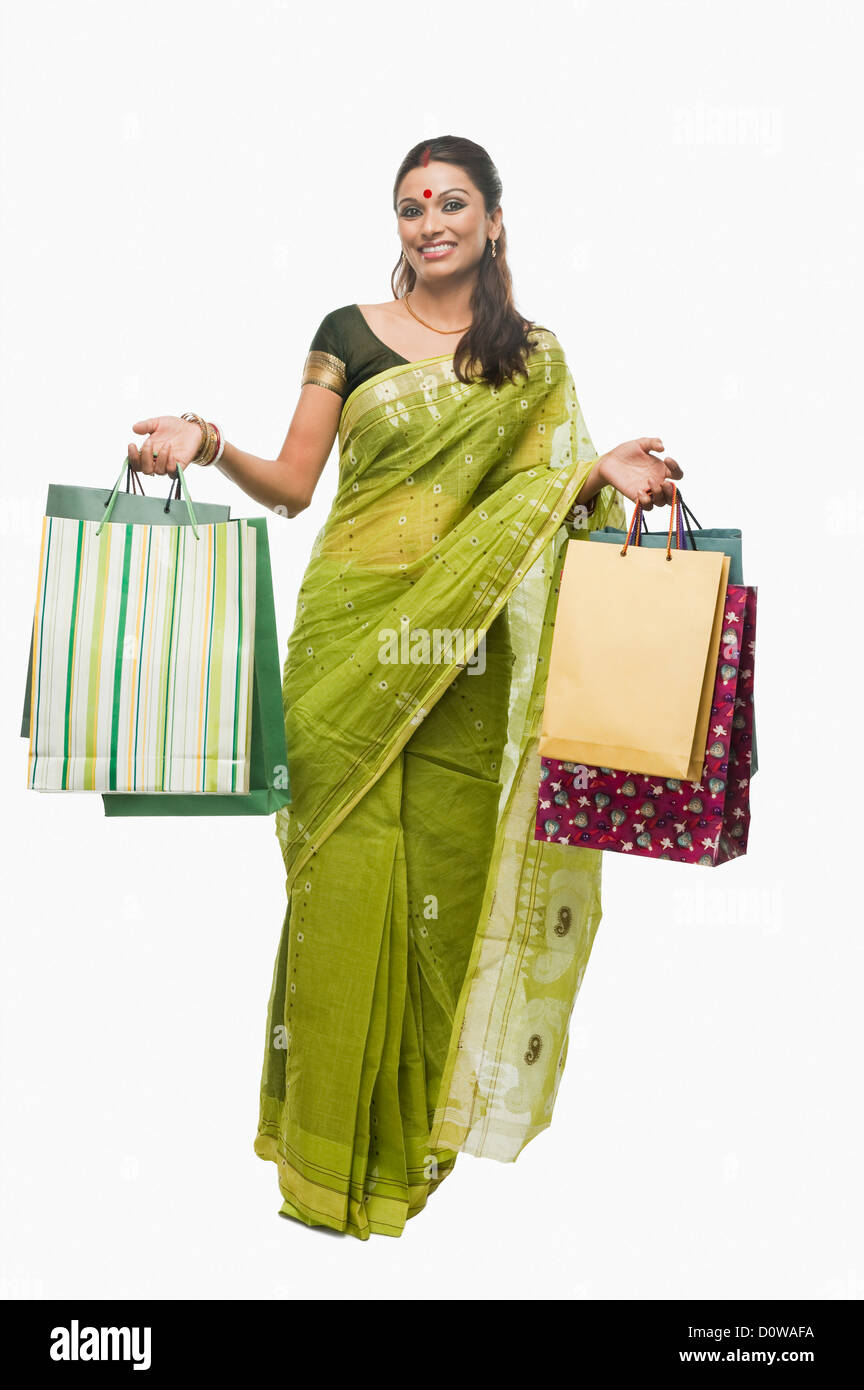 Bengali woman carrying shopping bags and smiling Stock Photo - Alamy