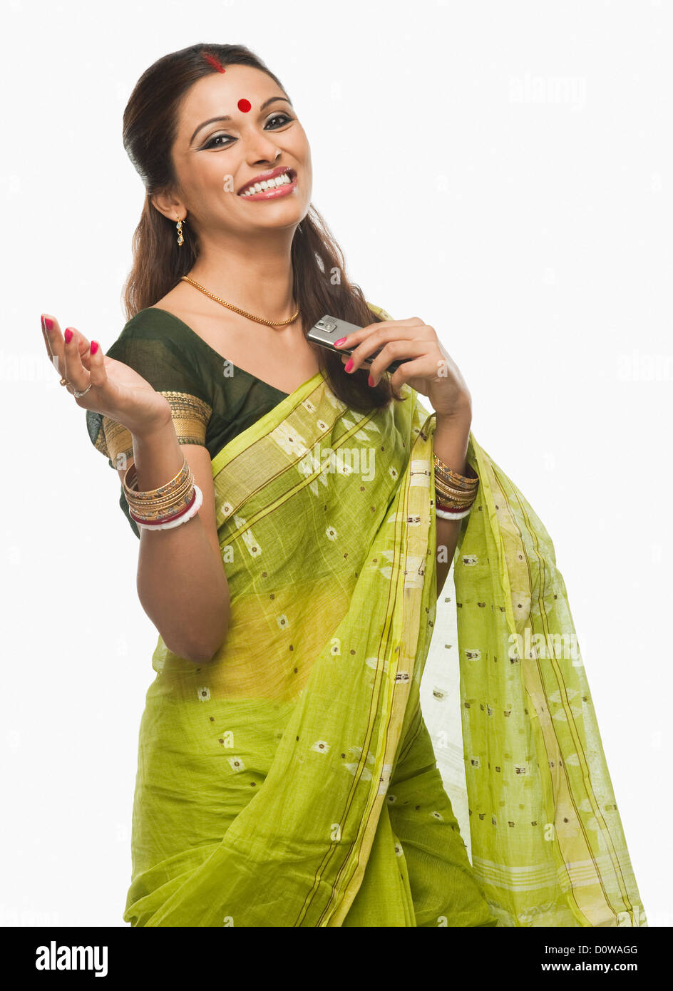 Bengali woman holding a mobile phone and smiling Stock Photo - Alamy