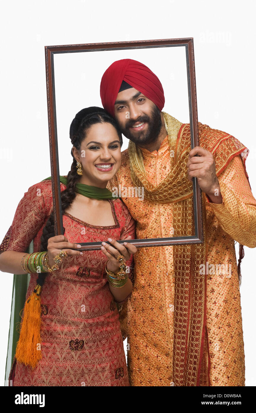Sikh couple holding an empty picture frame Stock Photo - Alamy
