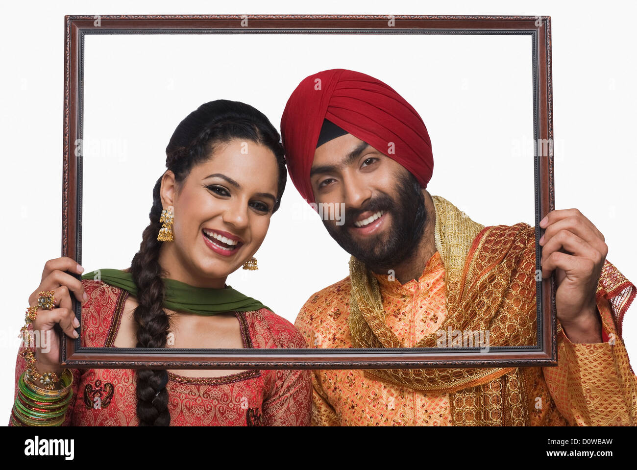 Sikh couple holding an empty picture frame Stock Photo - Alamy