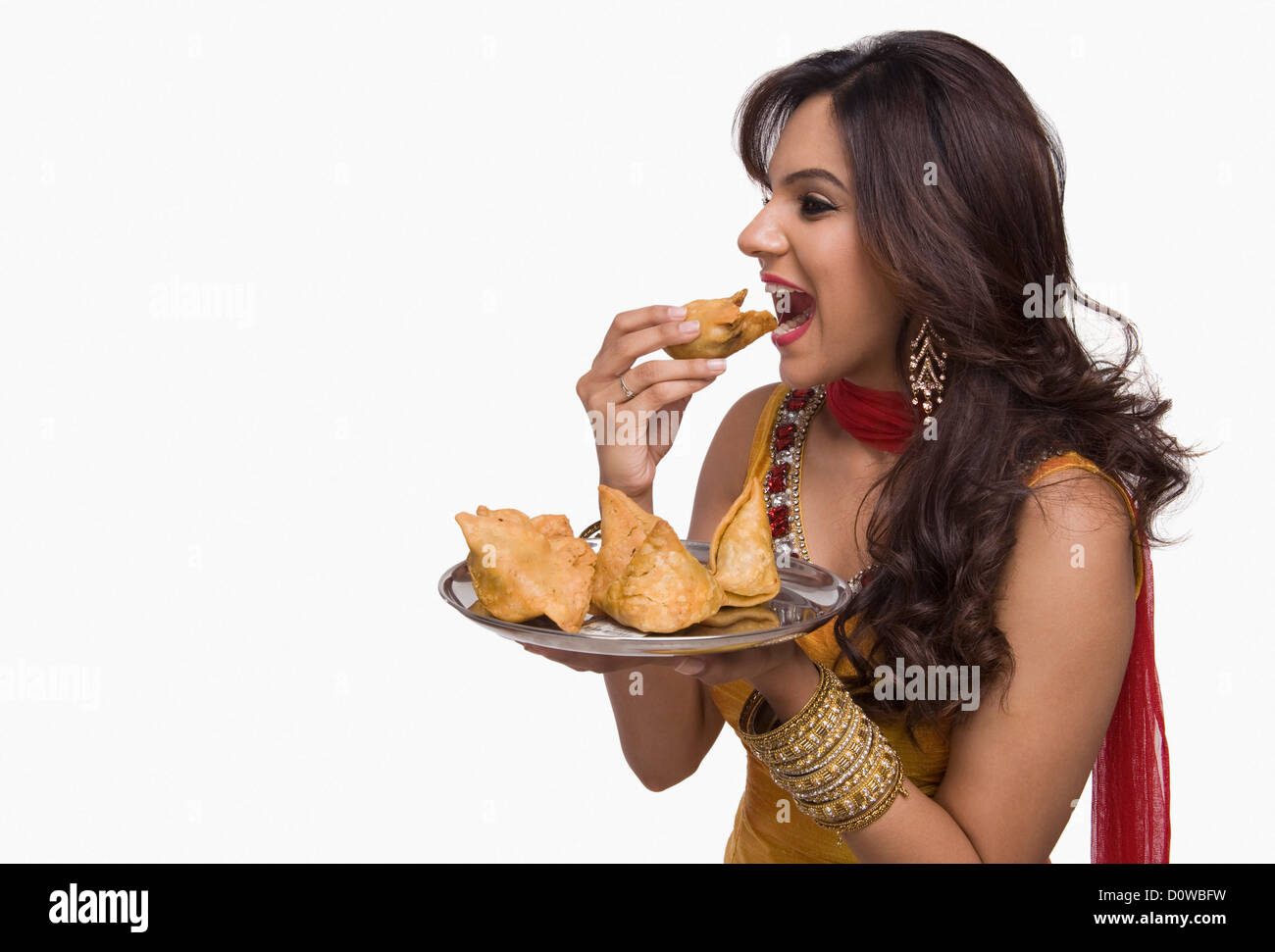 Beautiful indian woman eating Cut Out Stock Images & Pictures - Alamy