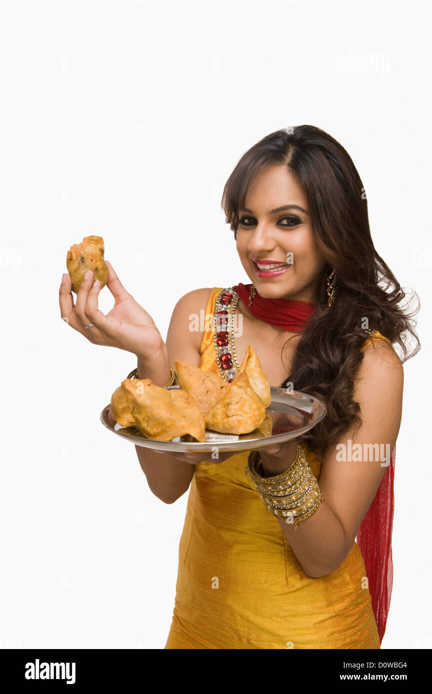 Woman holding a plate of samosa the traditional Indian snack Stock ...