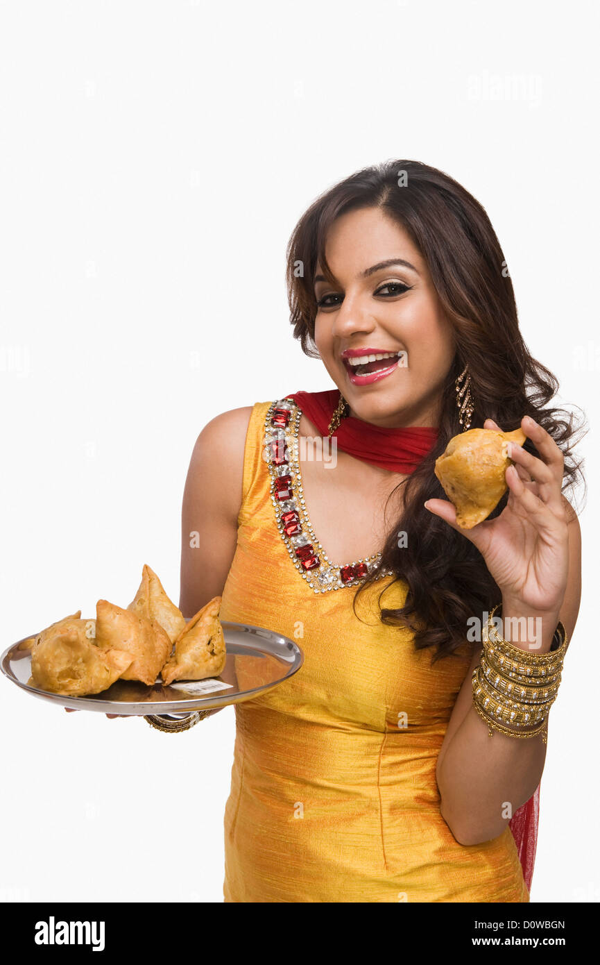 Woman holding a plate of samosa the traditional Indian snack Stock ...