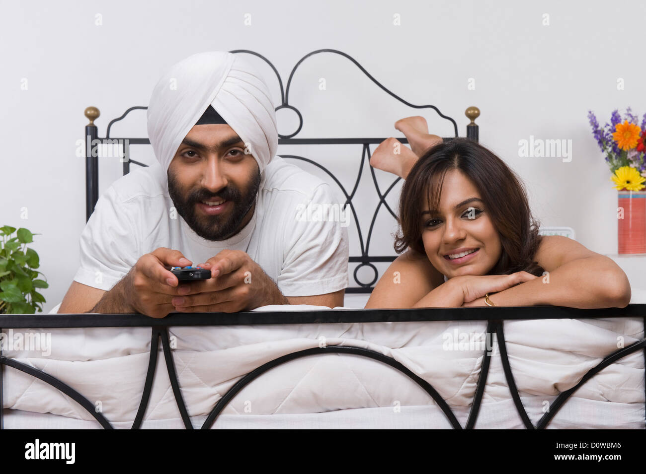 Portrait of a Sikh couple lying on the bed Stock Photo - Alamy