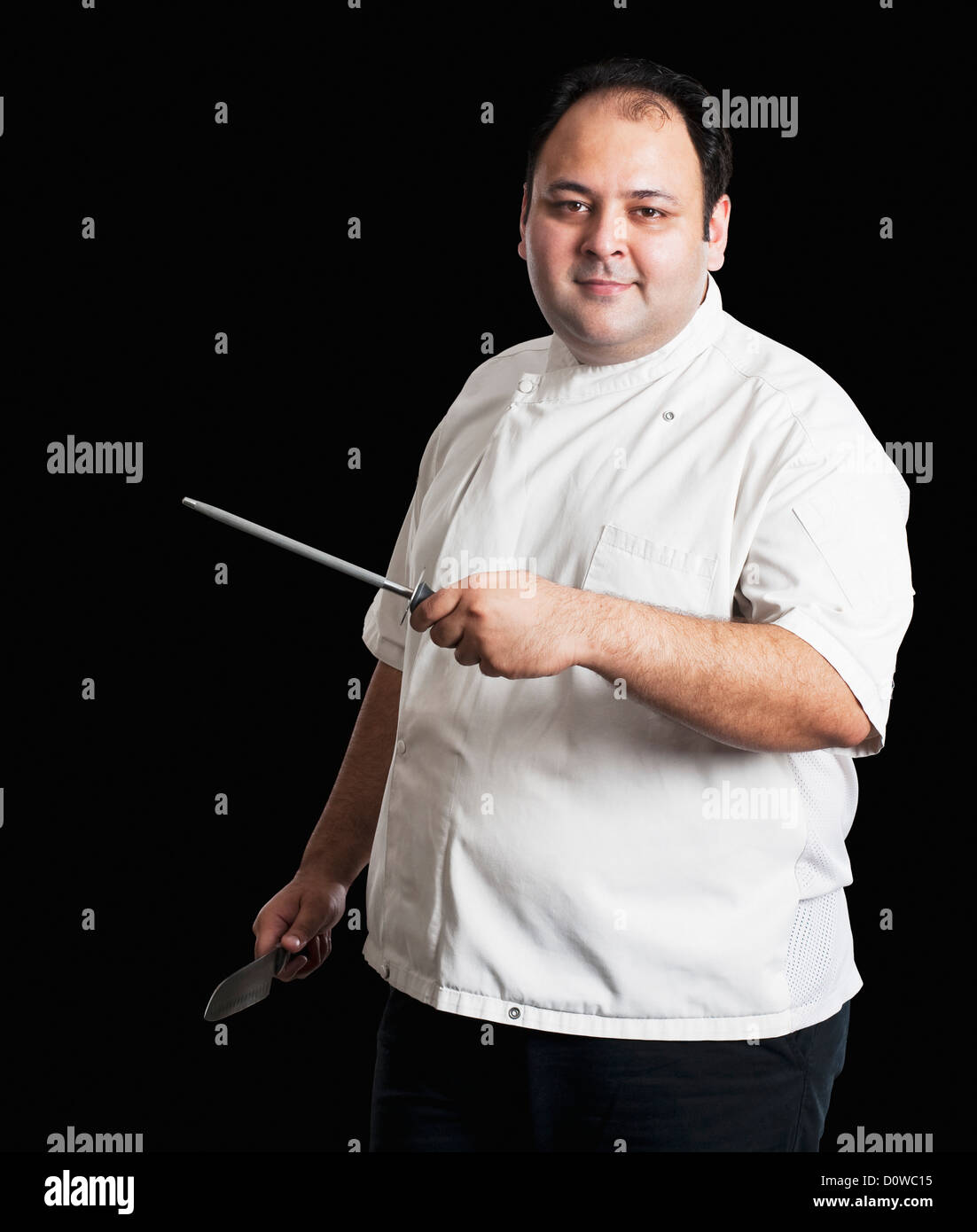 Portrait of a chef holding knives Stock Photo - Alamy