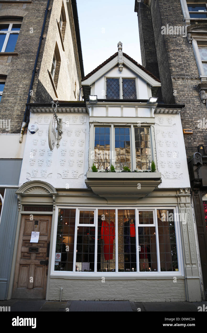 Small shop sandwiched between taller buildings Cambridge city England ...