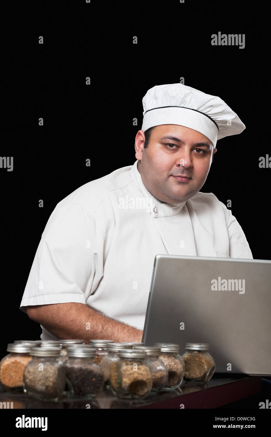 Chef with a laptop and assorted spices Stock Photo - Alamy