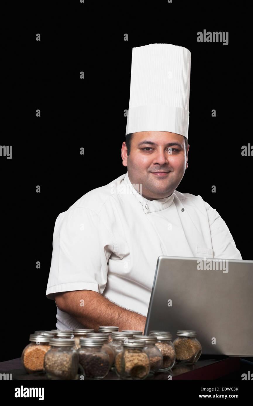 Chef with a laptop and assorted spices Stock Photo - Alamy