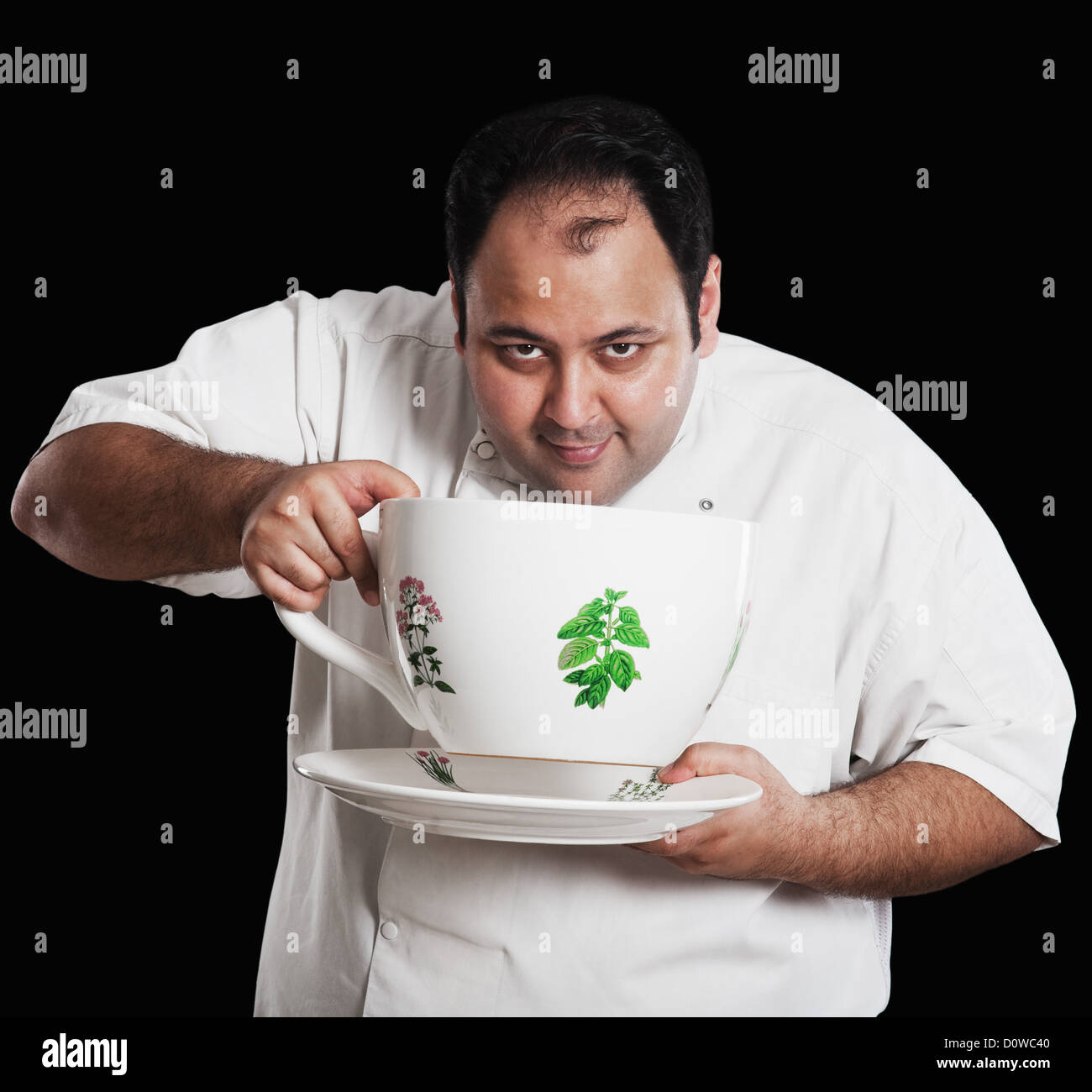 Chef drinking from an oversized cup Stock Photo - Alamy