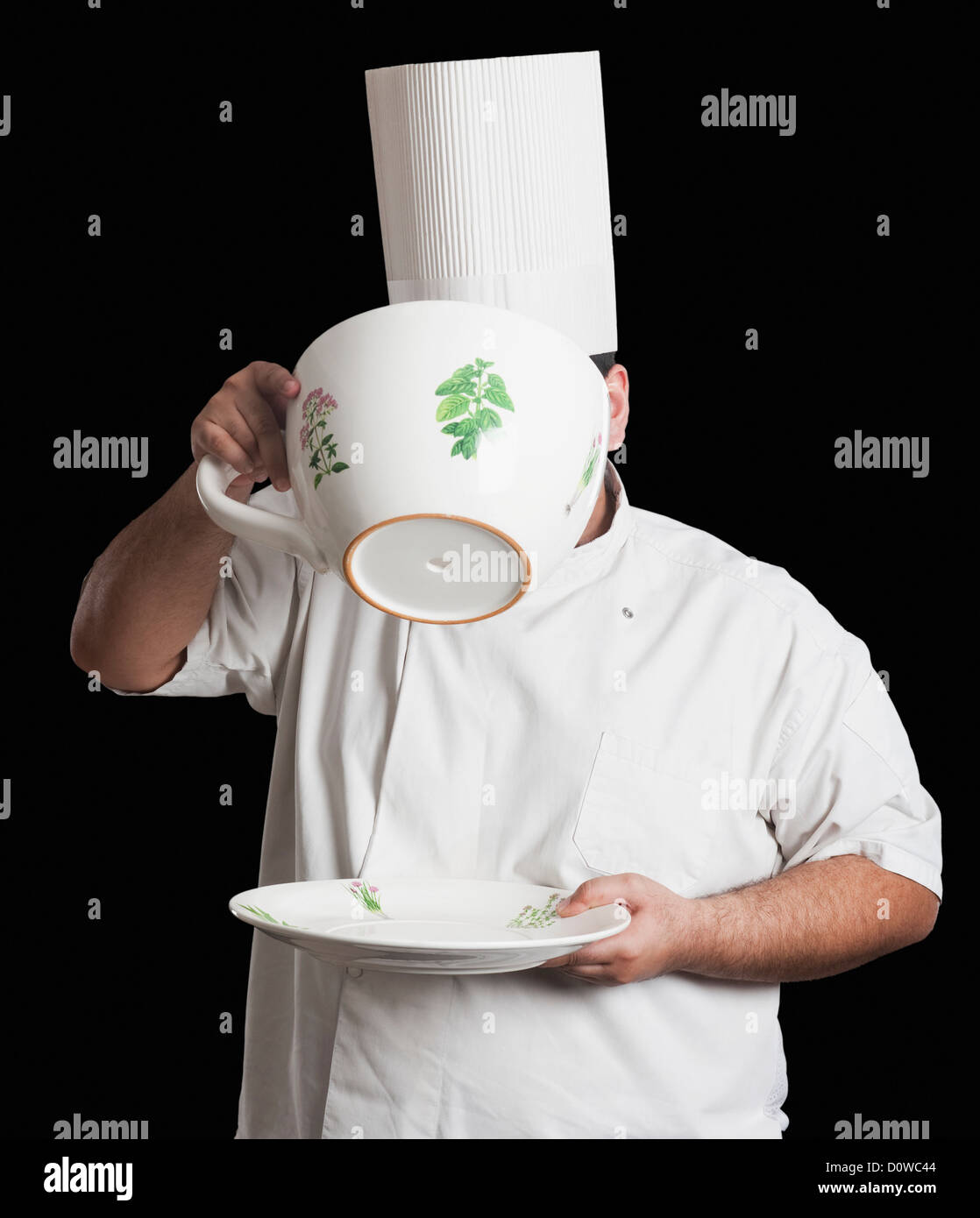 Chef drinking from an oversized cup Stock Photo - Alamy