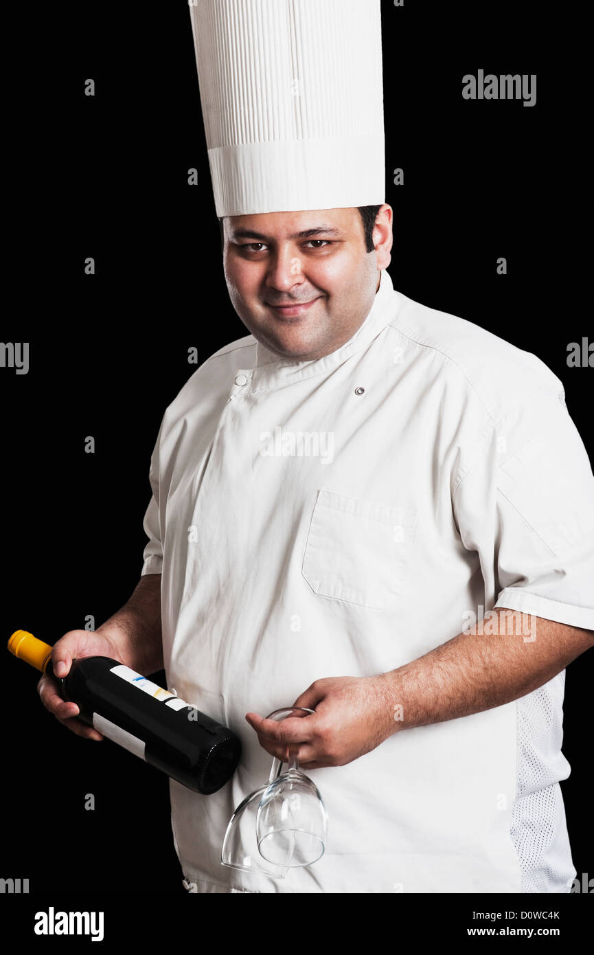 Chef holding wine bottle and wineglasses Stock Photo - Alamy