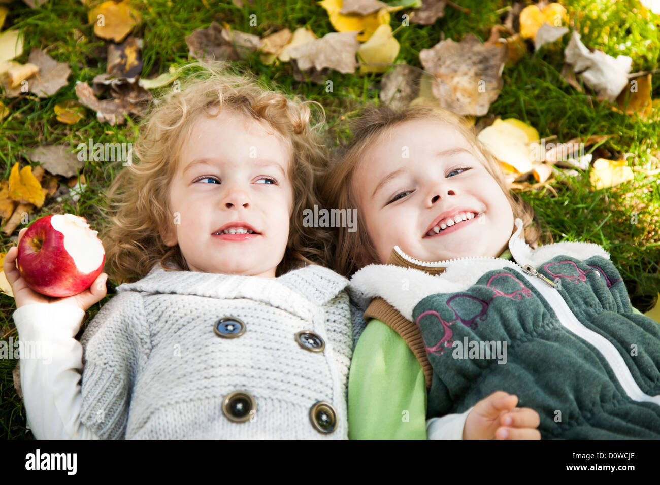 Happy children lying outdoors Stock Photo - Alamy