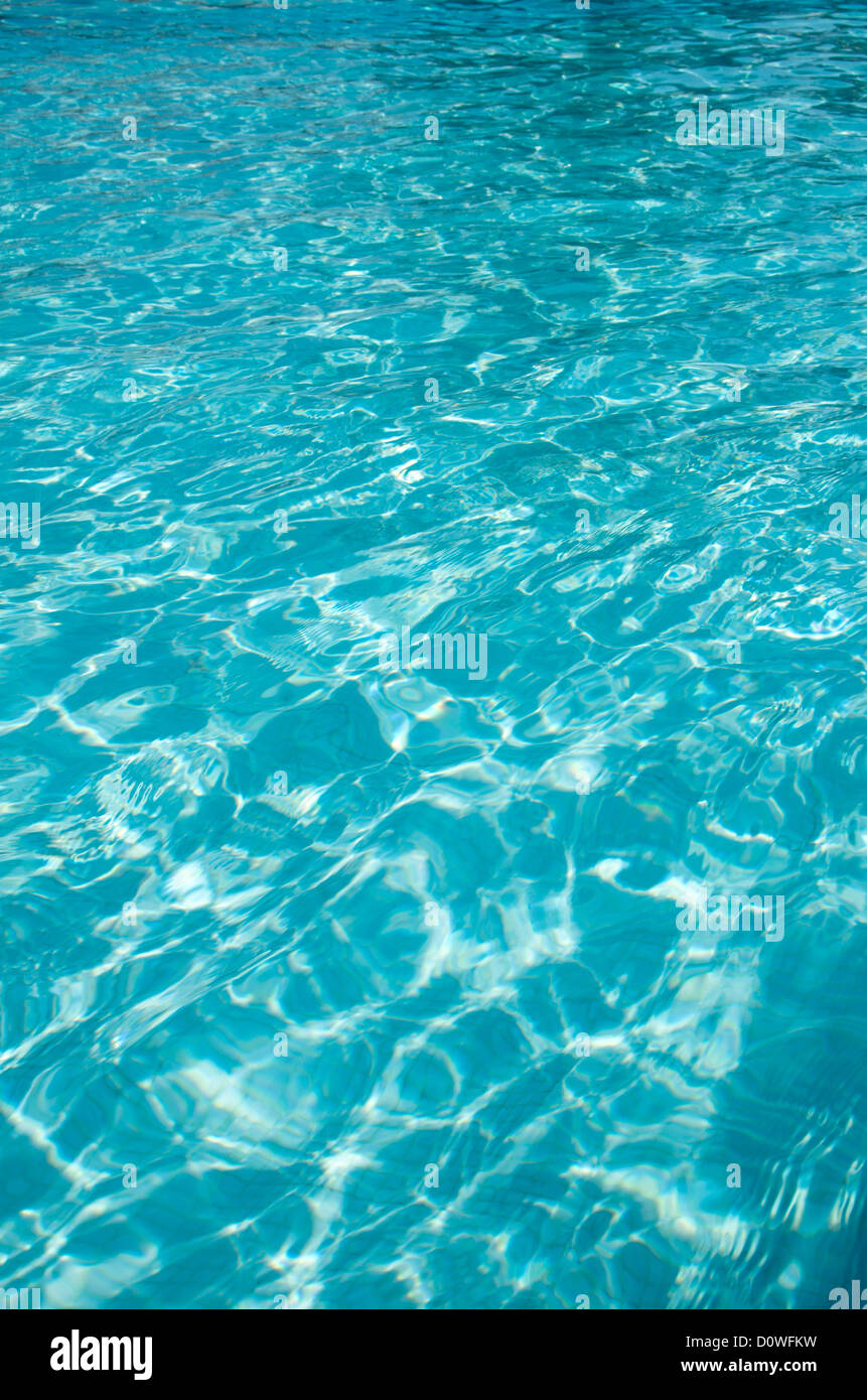 Blue pool water with sun reflections Stock Photo - Alamy