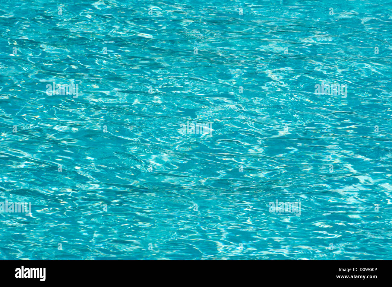 Blue pool water with sun reflections Stock Photo - Alamy