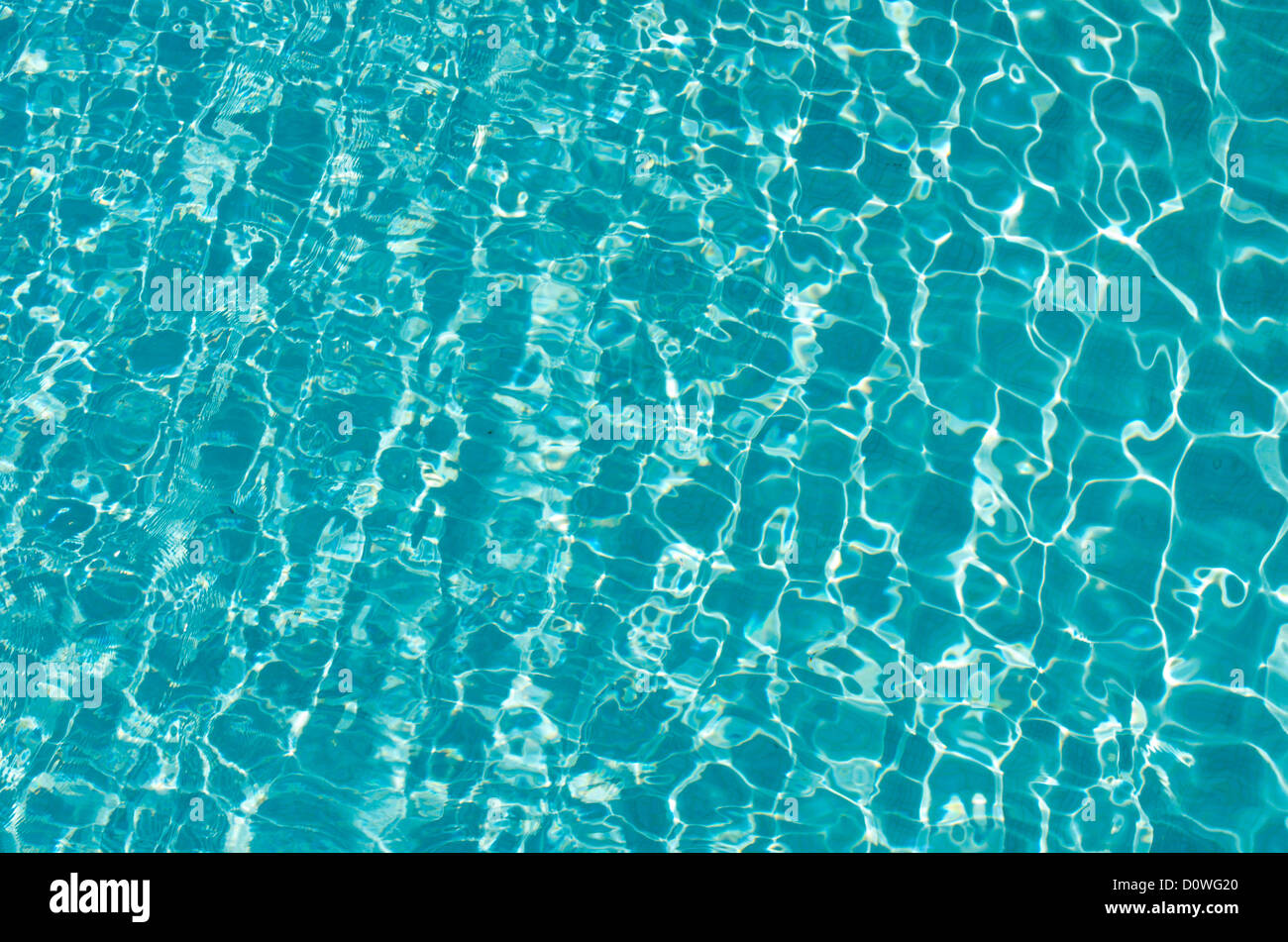 Blue pool water with sun reflections Stock Photo - Alamy