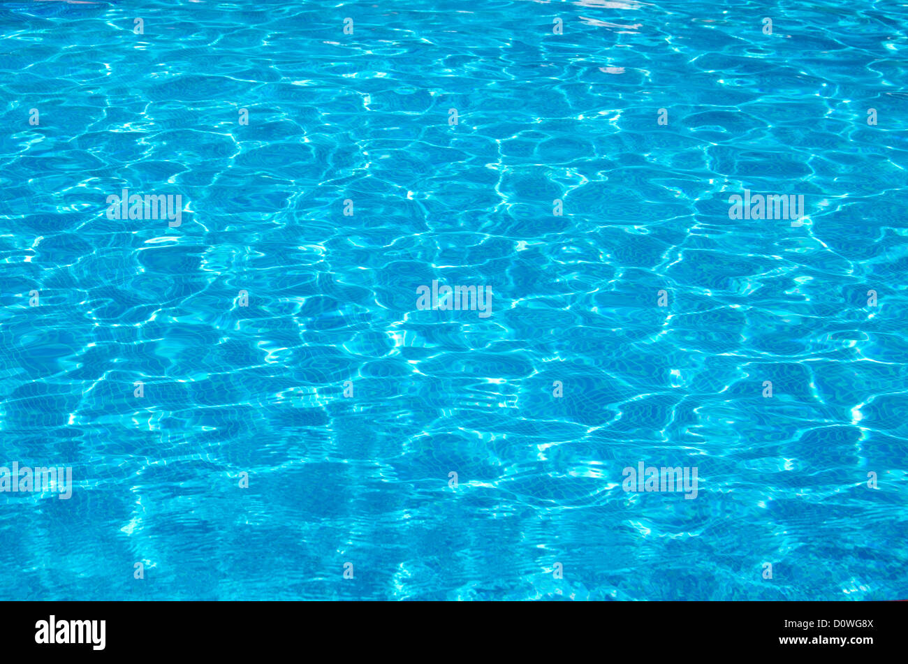 Blue pool water with sun reflections Stock Photo - Alamy