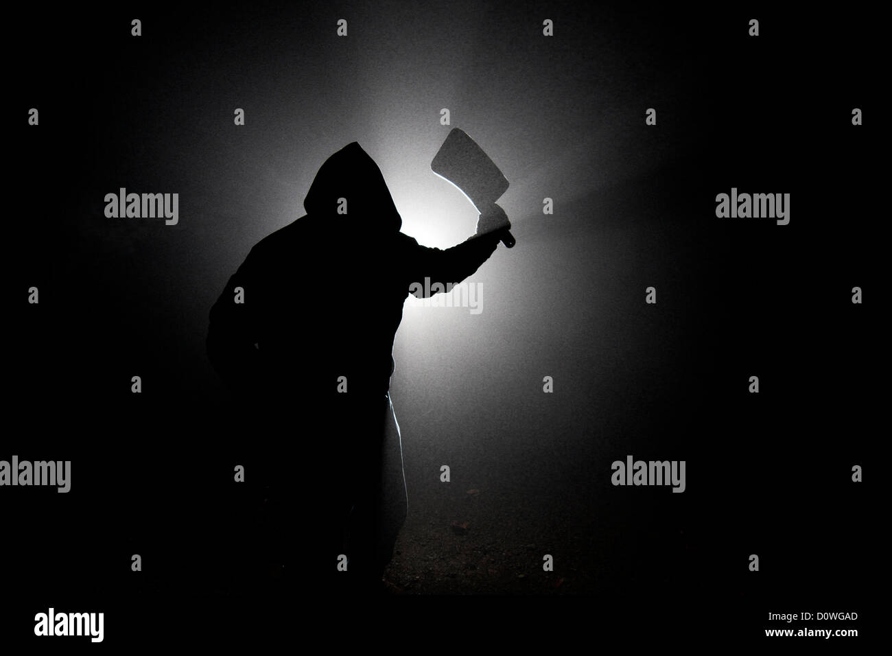 Cleaver Killer: Dark, foggy outdoor silhouette of a man wielding a ...